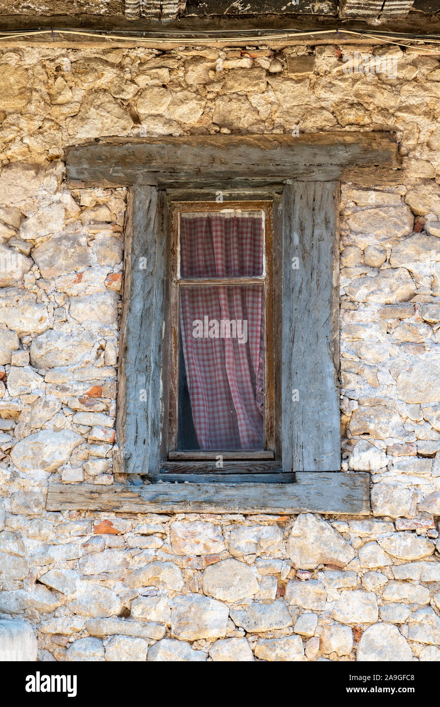 An old window in a medieval stone building in Eguisheim Alsace France ...