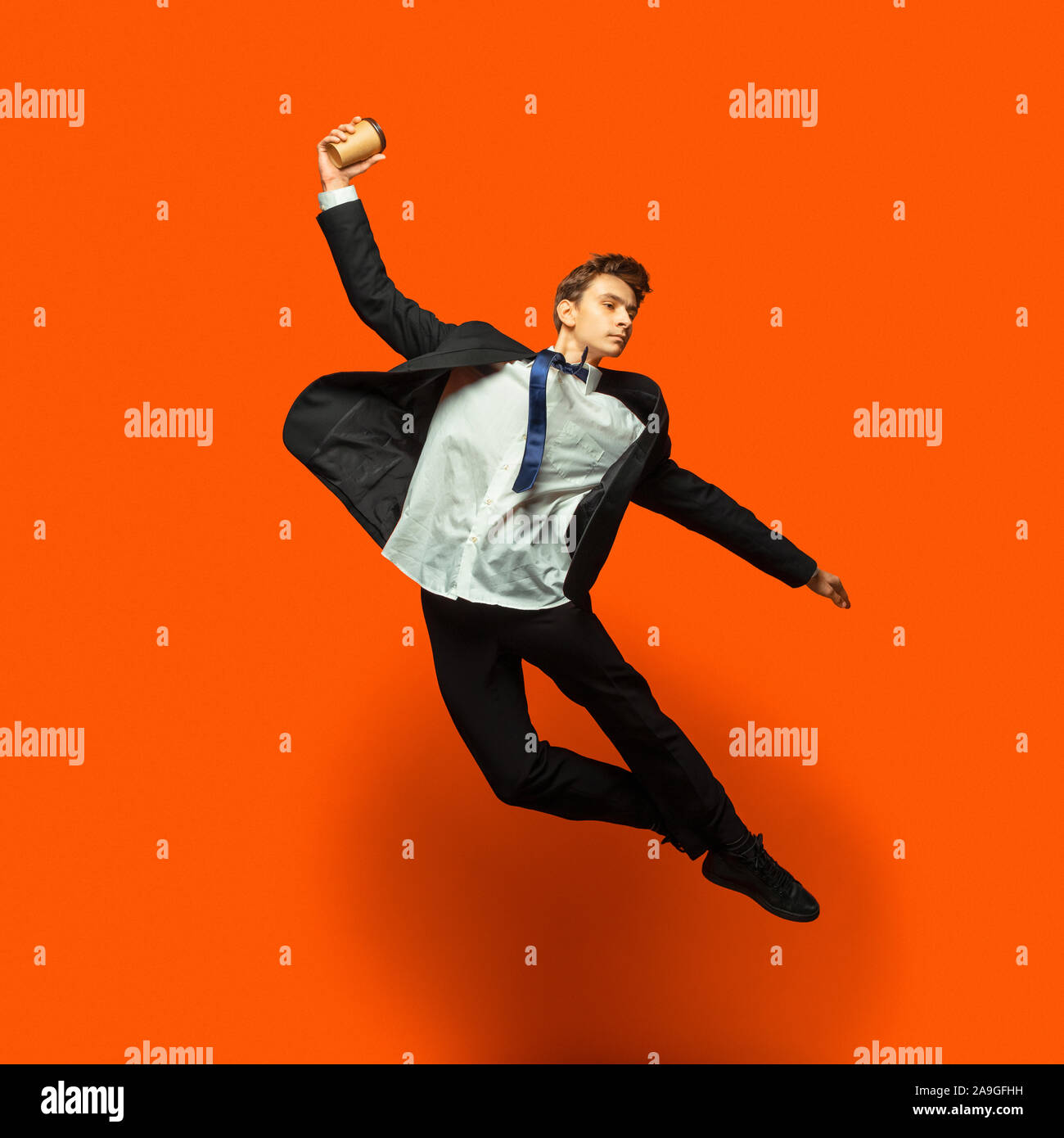 Man in casual office style clothes jumping and dancing isolated on ...