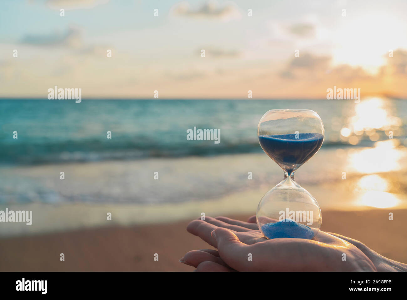 Time is running fast. Hourglass in the hands symbolize the transience ...