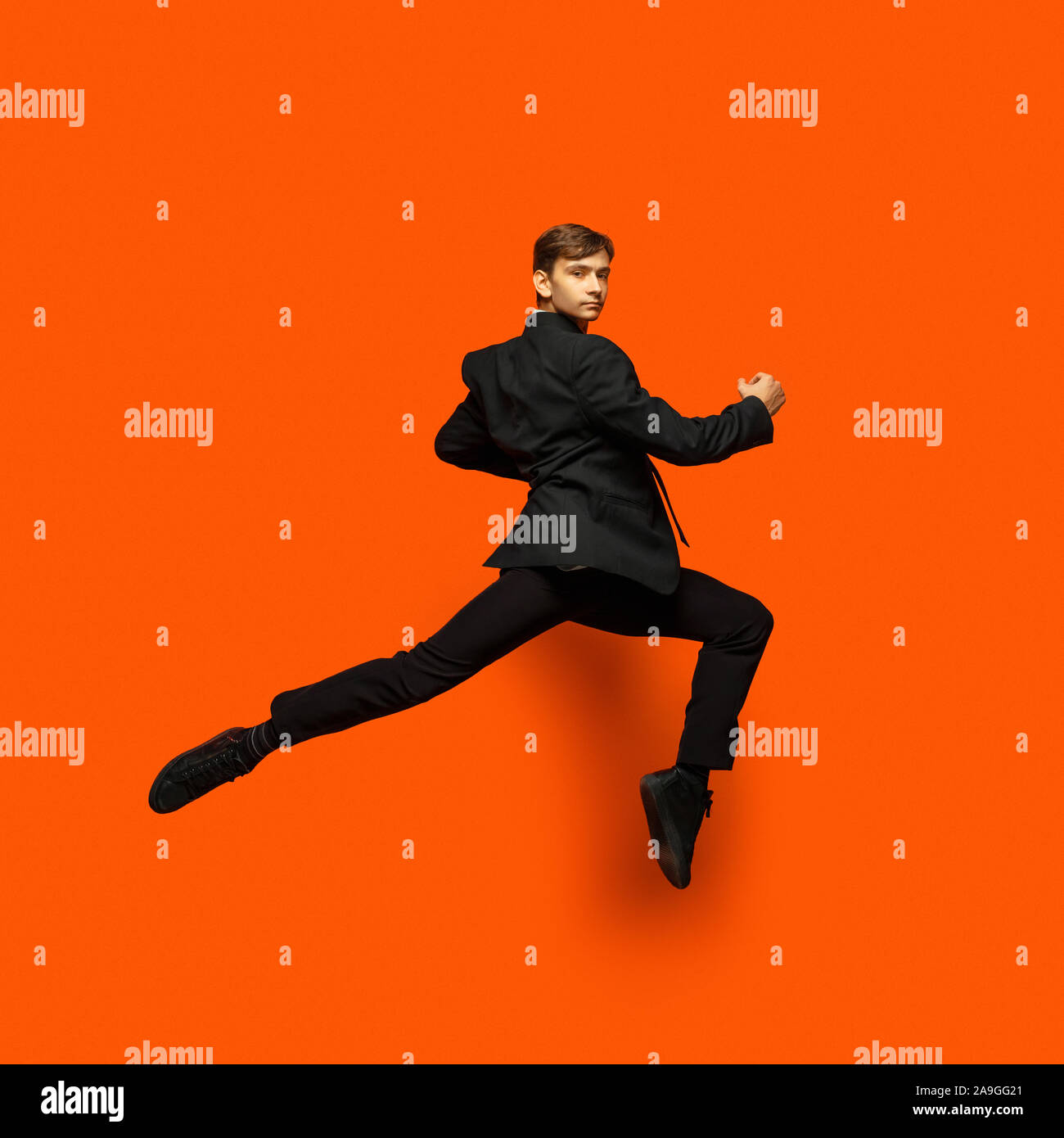 Man in casual office style clothes jumping and dancing isolated on ...