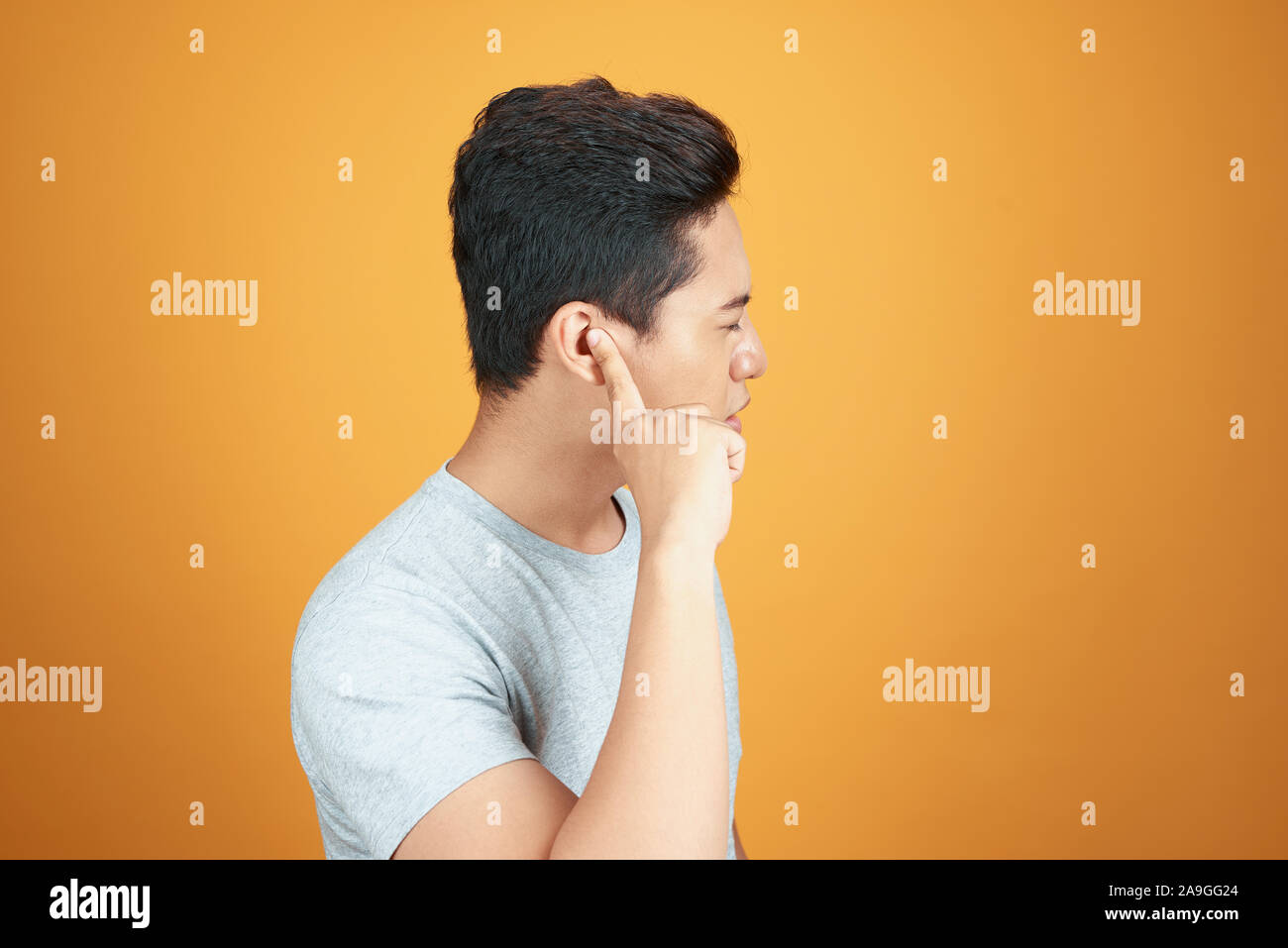 the Asian man raised his ears to the hearing with his hand Stock Photo ...