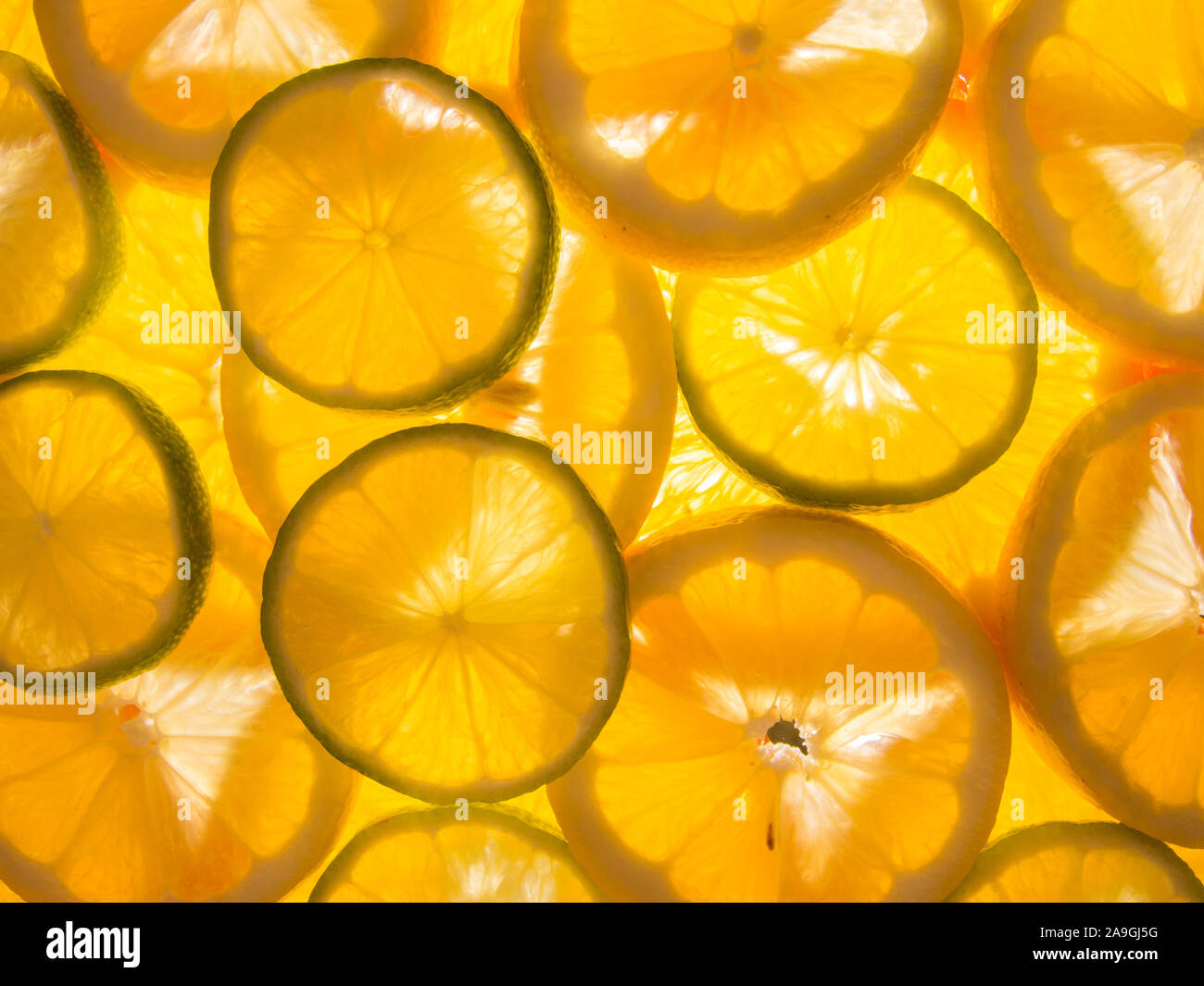 Orange lemon lime slices lit from below Stock Photo - Alamy