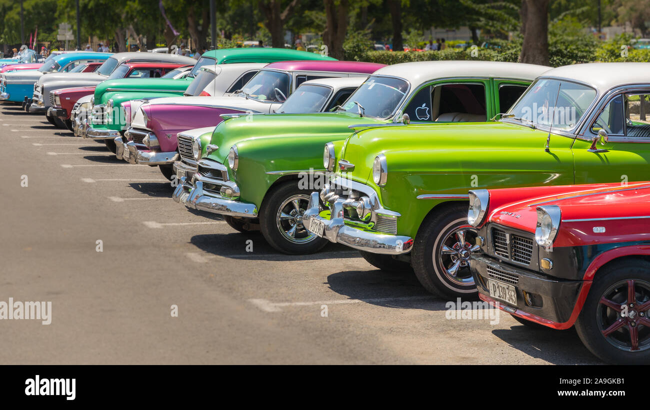 Havana, Cuba - July 23, 2018; A row of typical colorful Cuban oldtimer ...