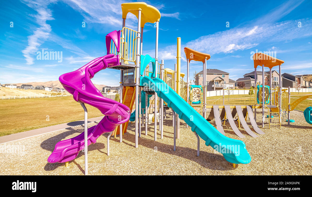 Panorama Colorful blue and purple slides in kids playground Stock Photo ...