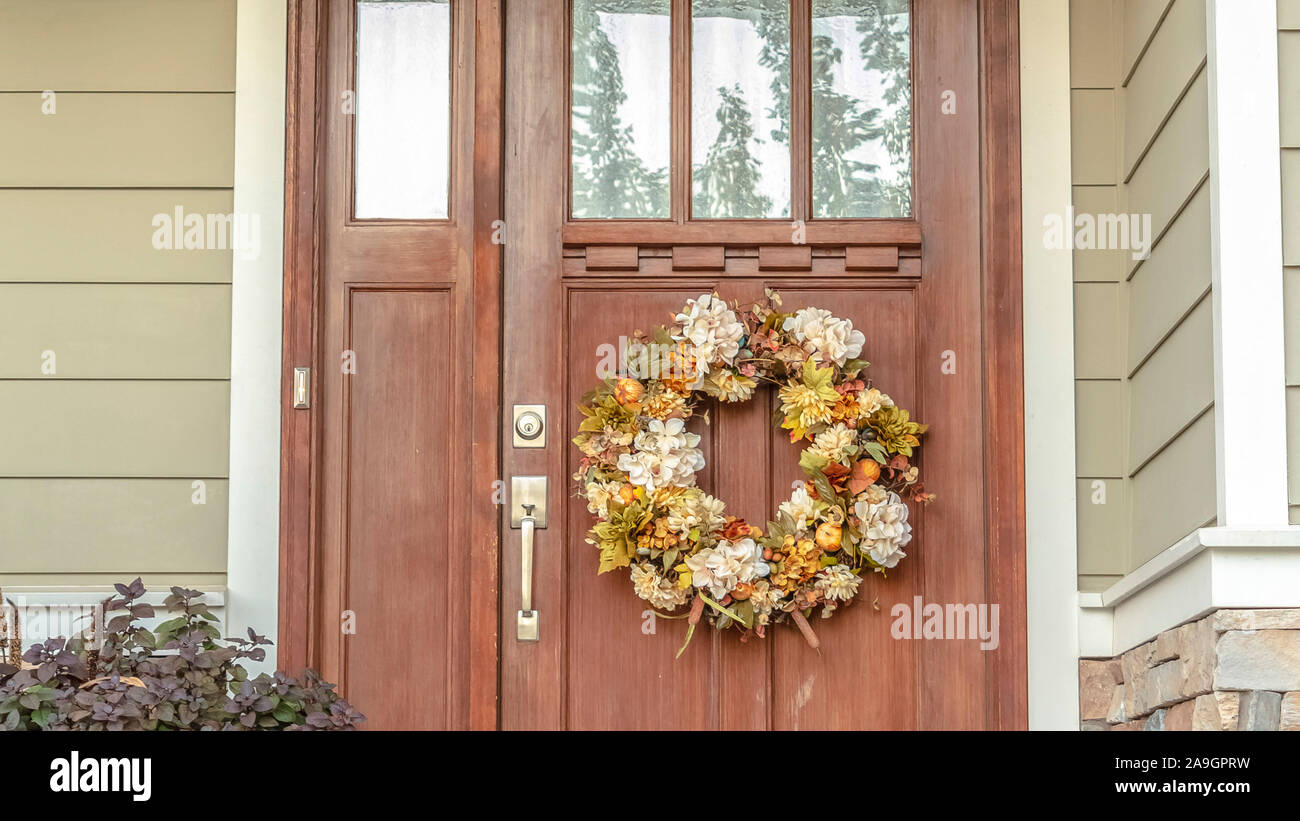 Panorama frame Front door with dried flower wreath day Stock Photo - Alamy