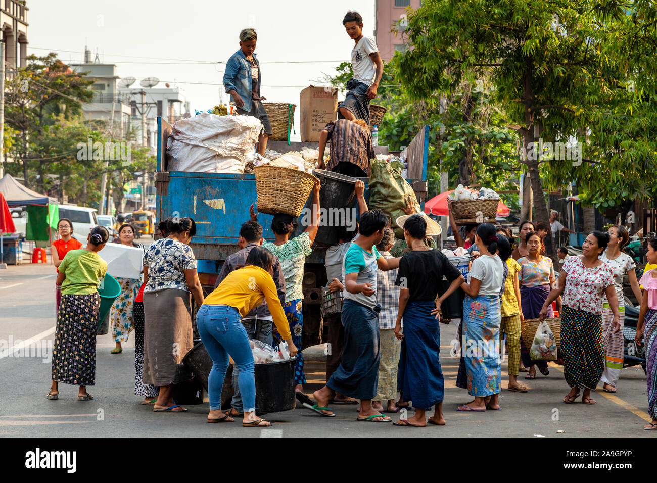 Local People Pass Up Their Garbage/Rubbish On To A Garbage Collection ...