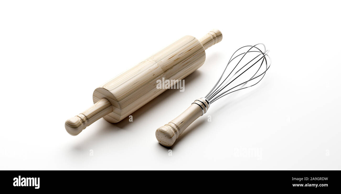 Wire whisk and rolling pin kitcenware utensils isolated against white ...