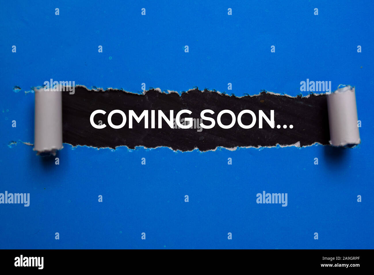 Coming Soon Text written in torn paper Stock Photo - Alamy