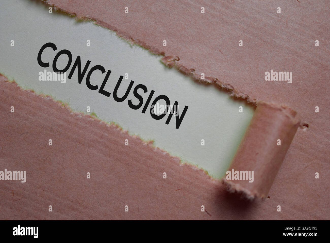 Conclusion Text written in torn paper Stock Photo - Alamy