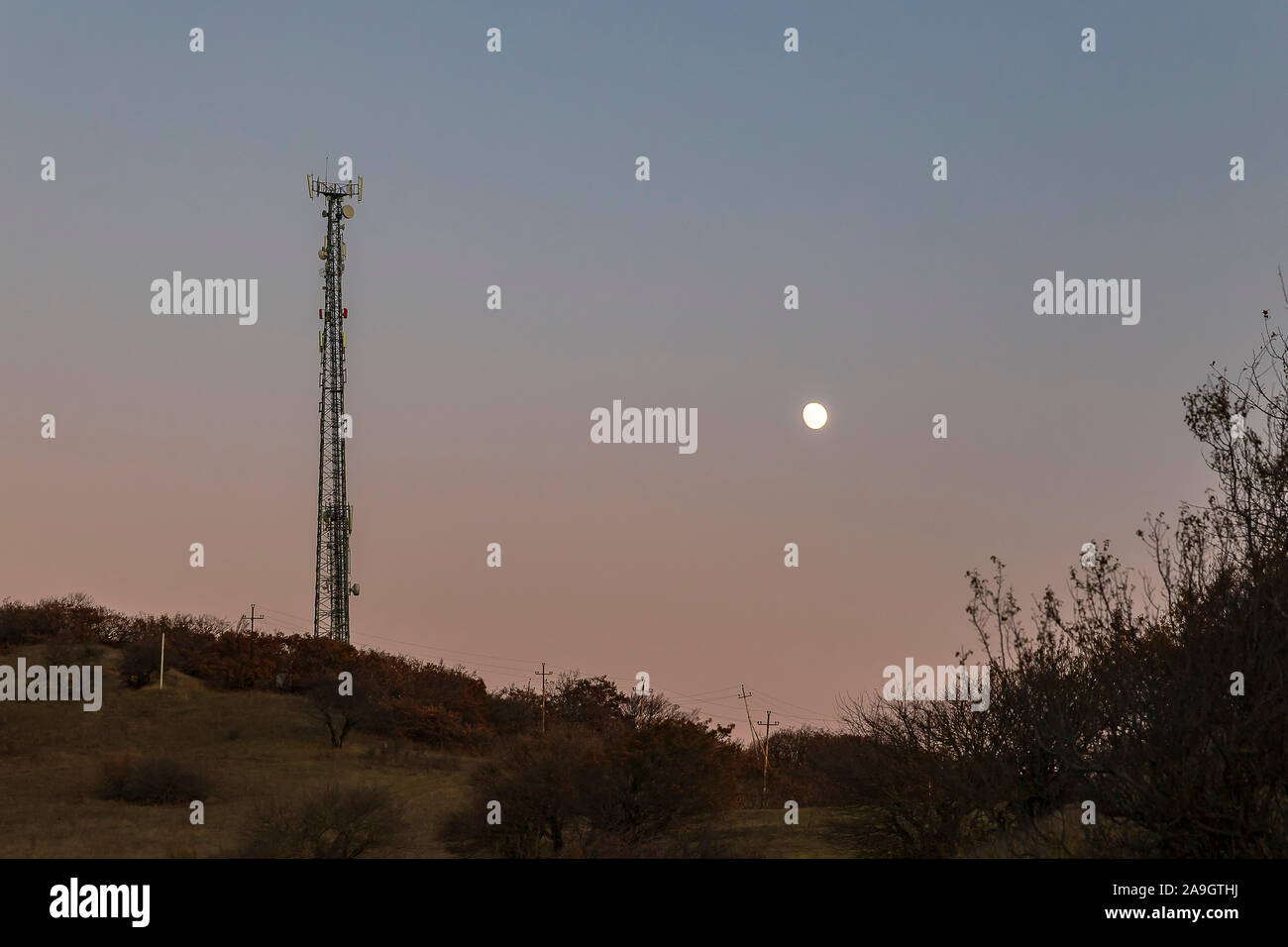 Cell tower and the rising moon Stock Photo - Alamy