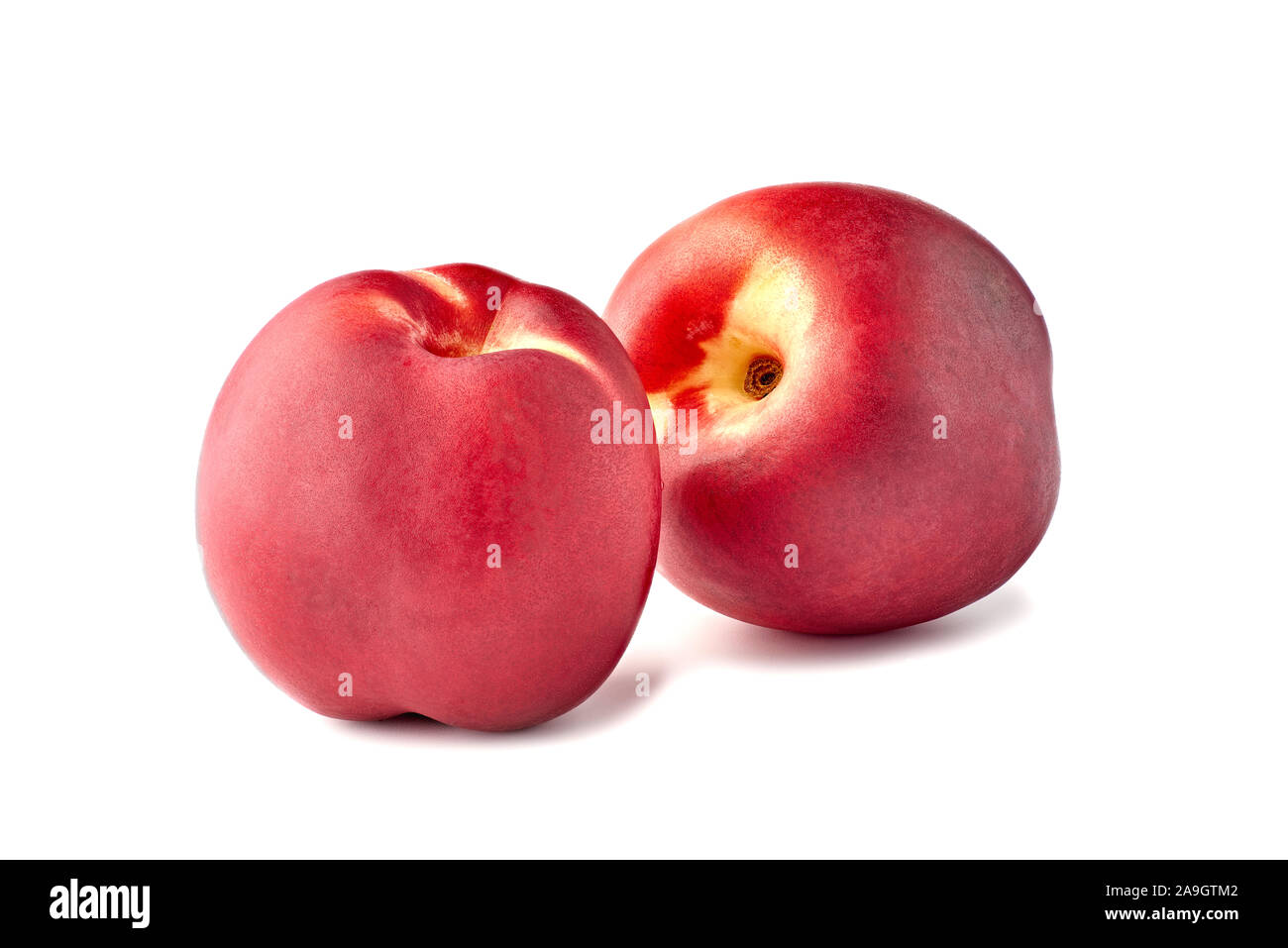 Two ripe nectarines on white background Stock Photo - Alamy
