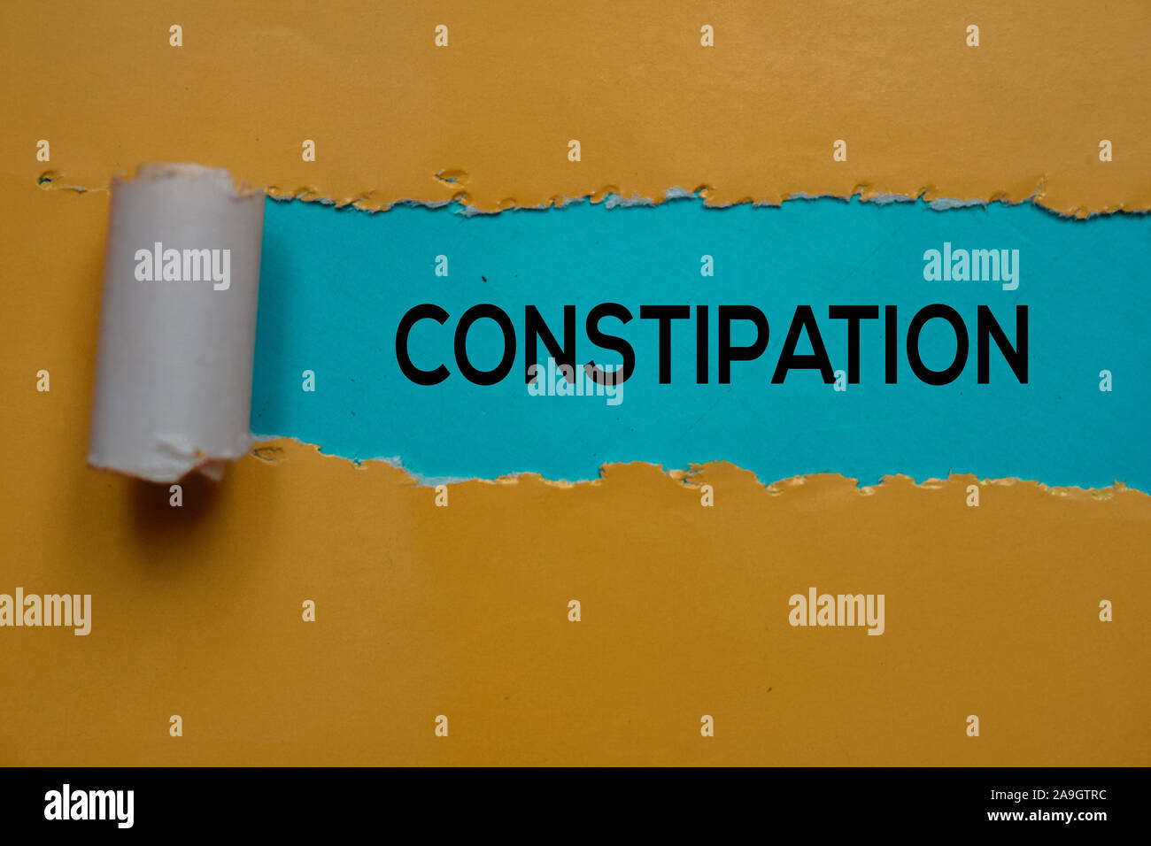 Constipation Text written in torn paper. Medical concept Stock Photo ...