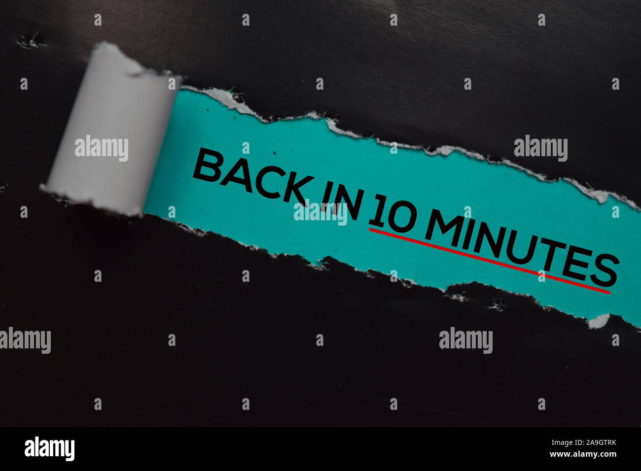 Back In 10 Minutes Text written in torn paper Stock Photo - Alamy