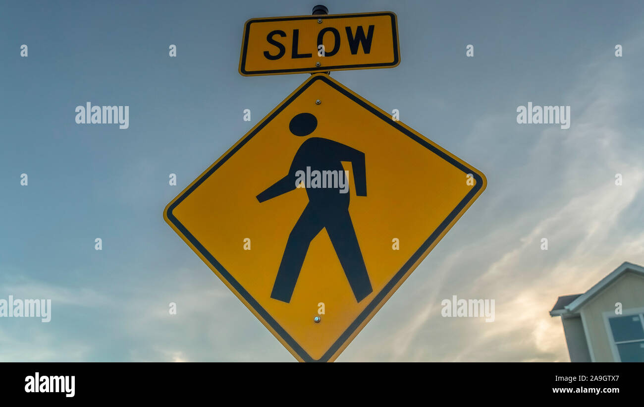 Panorama frame Yellow Slow sign and pedestrian crossing sign against ...