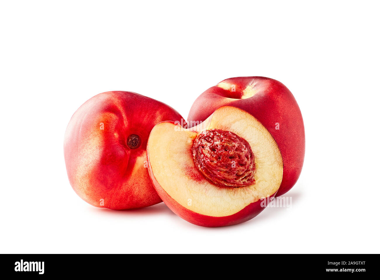 Two and slice of half nectarines on white background Stock Photo - Alamy