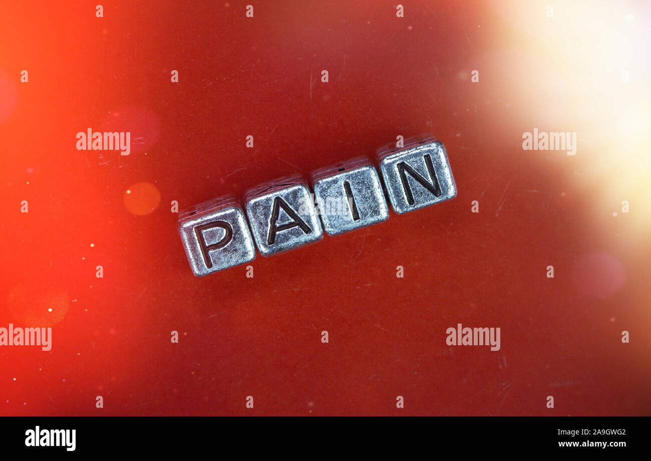Pain disease background concept represented by cubic metal letters ...