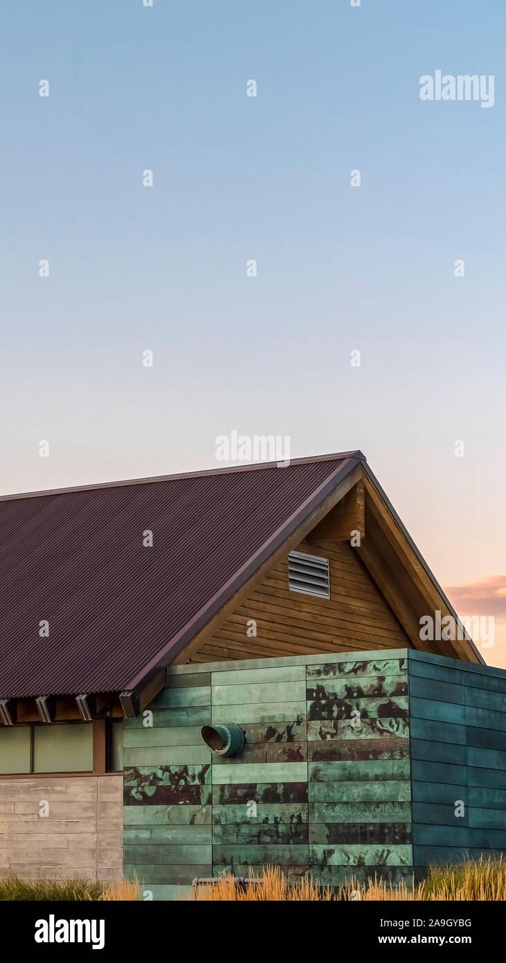 Vertical Building with gable roof and decorative wall Stock Photo - Alamy