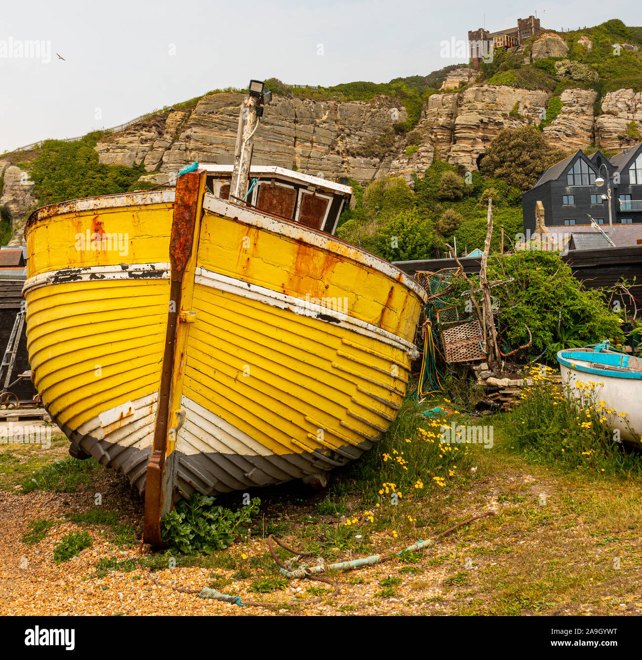 Old beached yellow fishing boat Stock Photo - Alamy