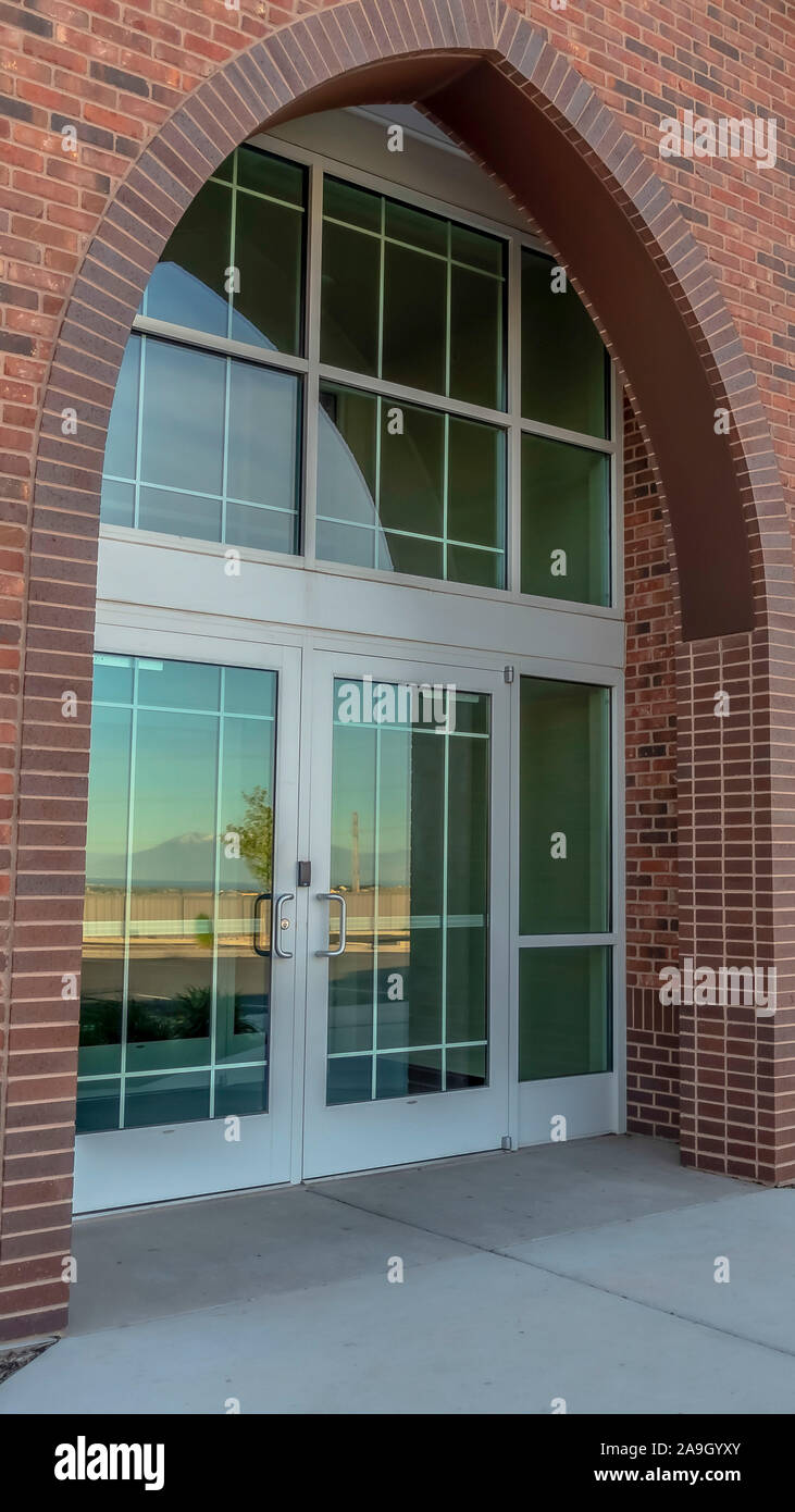 Vertical frame Arched entrance of a church with white framed double ...