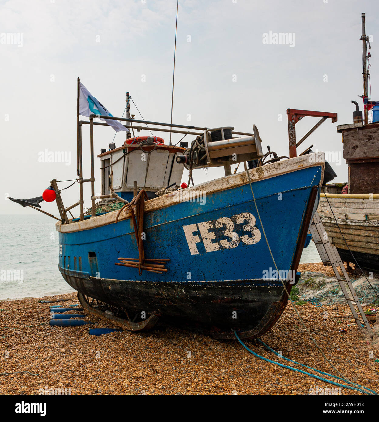 Beached blue fishing boat Stock Photo - Alamy