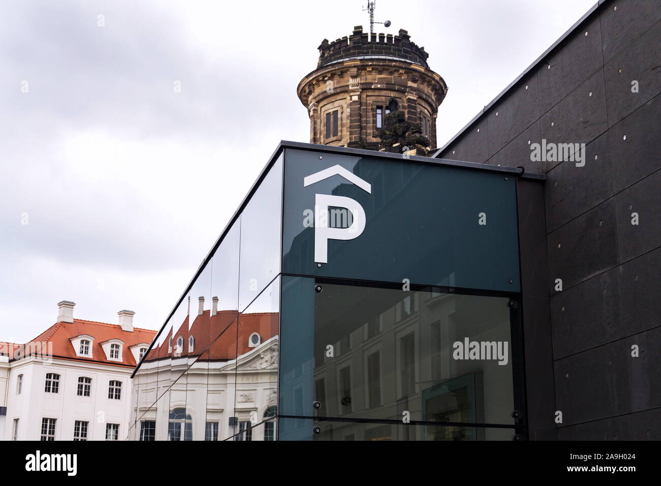 Covered underground parking sign on glass wall in historical center ...