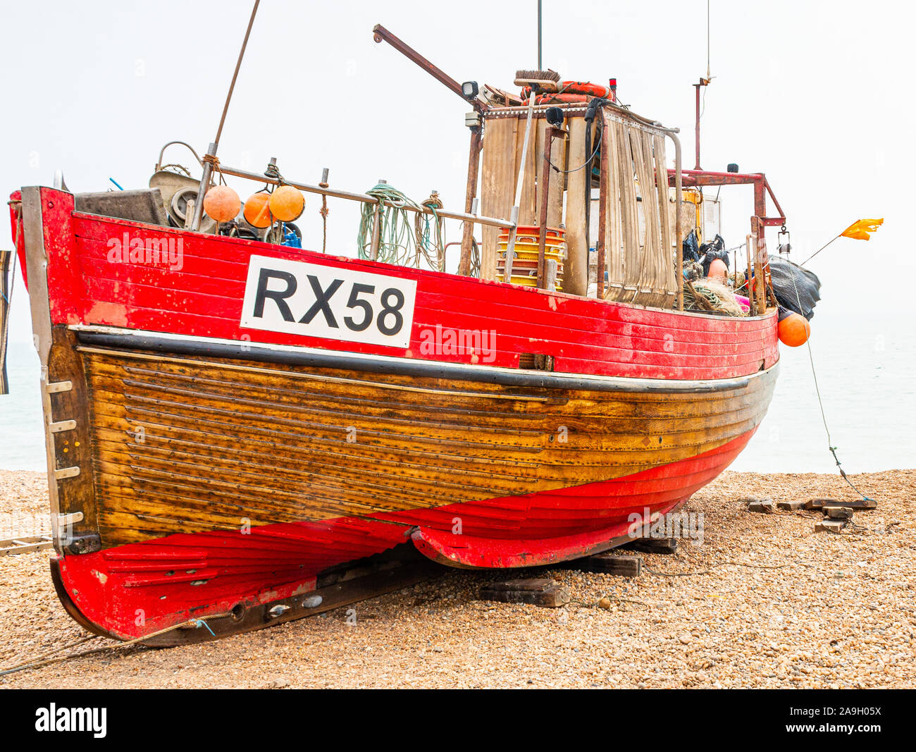 Beached red fishing boat Stock Photo - Alamy