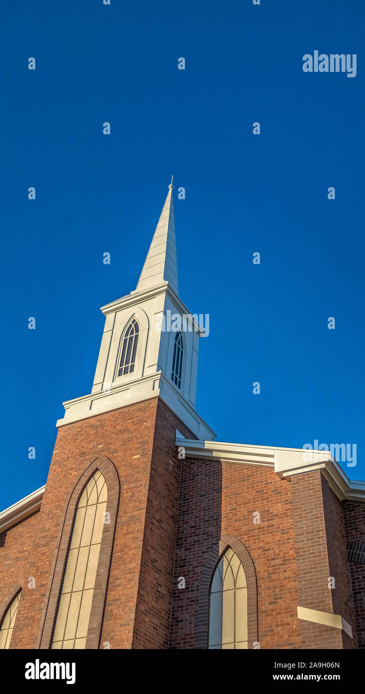 Vertical frame Church with classic red brick exterior wall and white ...
