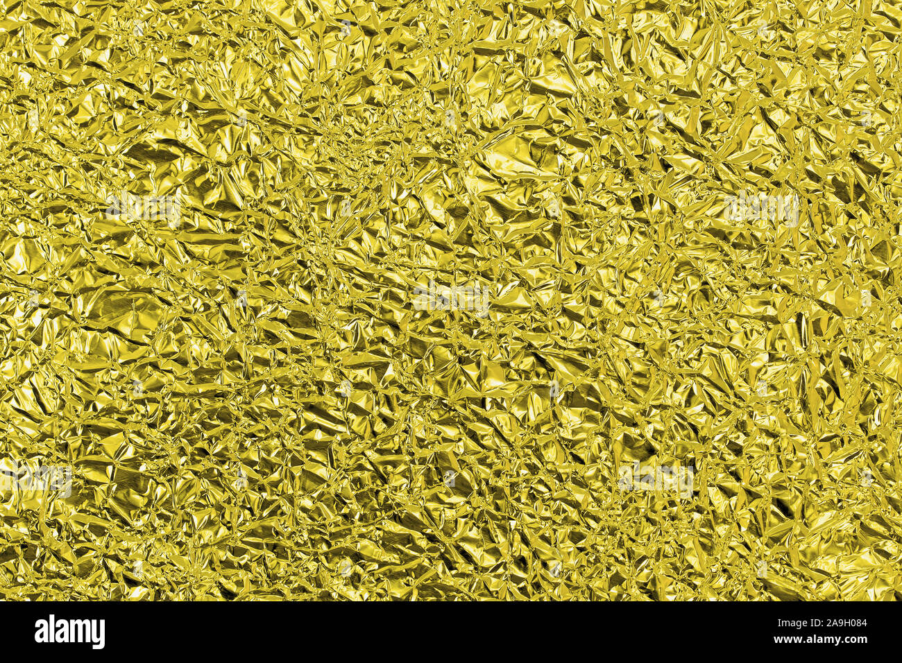 Golden aluminum foil as a background Stock Photo - Alamy