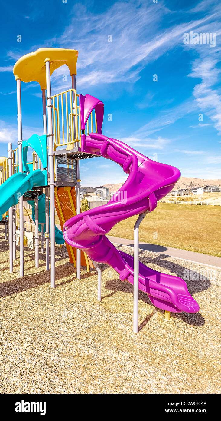 Vertical frame Colorful blue and purple slides in kids playground Stock ...