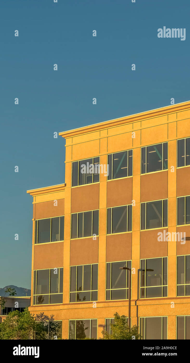 Vertical frame Commercial building exterior with mountain and sky ...