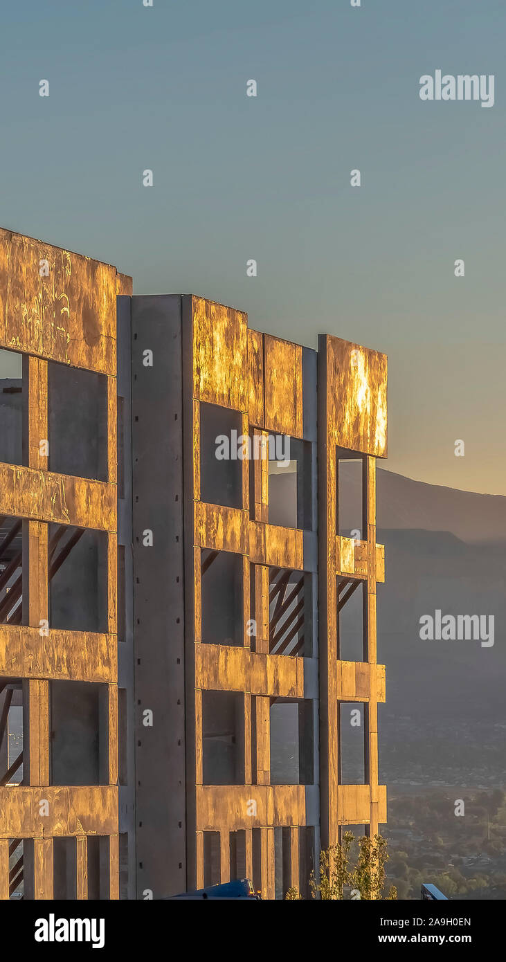 Vertical frame Construction of a modern building with mountain and sky ...