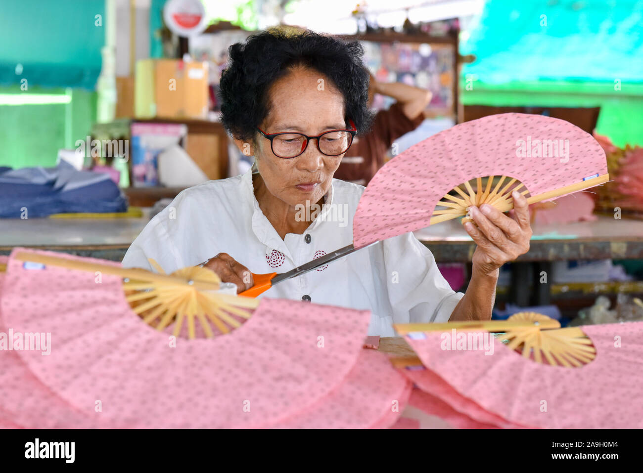Senior woman making Handmade paper fans at Bo Sang next to Chiang Mai ...