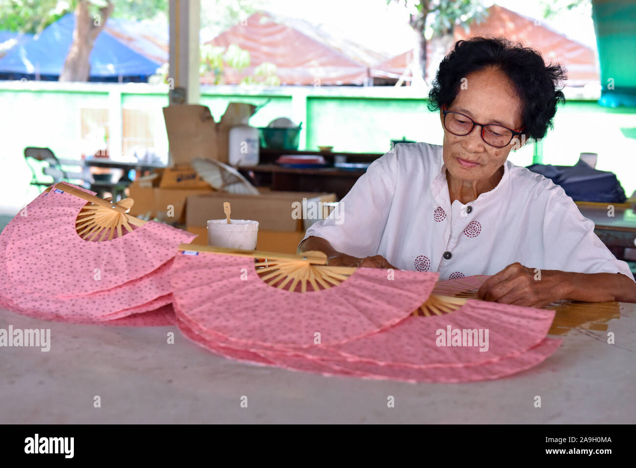Old Thai lady making Hand fans at Bo Sang next to Chiang Mai, Thailand ...