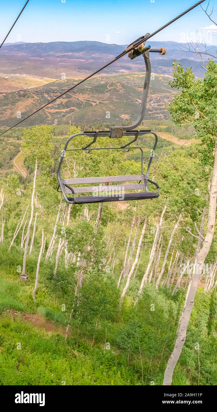 Vertical frame Hiking trails and chairlifts at a ski resort covered ...