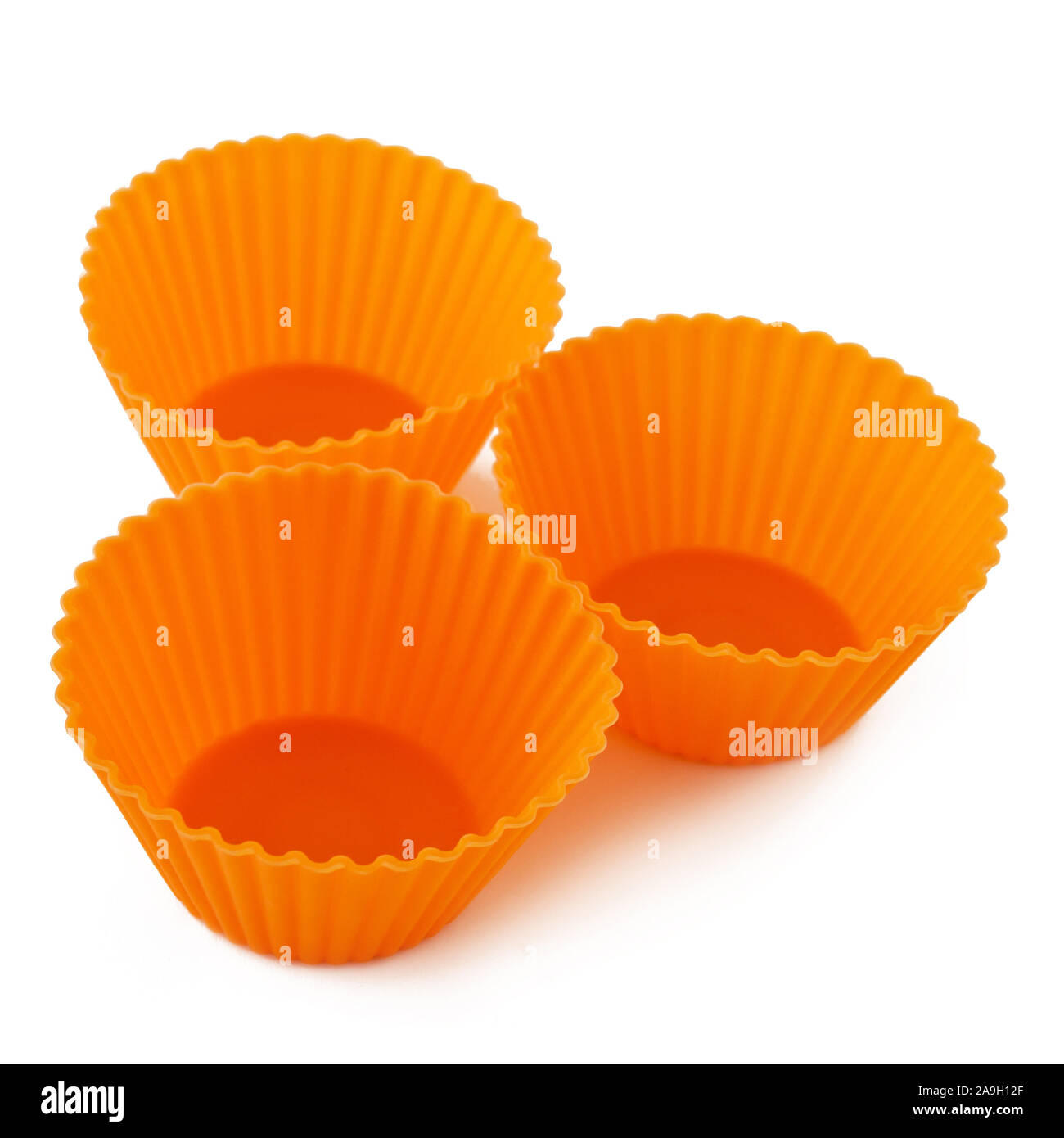 Three baking forms on white background Stock Photo - Alamy