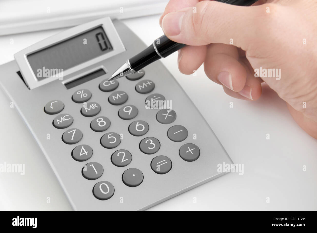 Male hand and calculator Stock Photo - Alamy