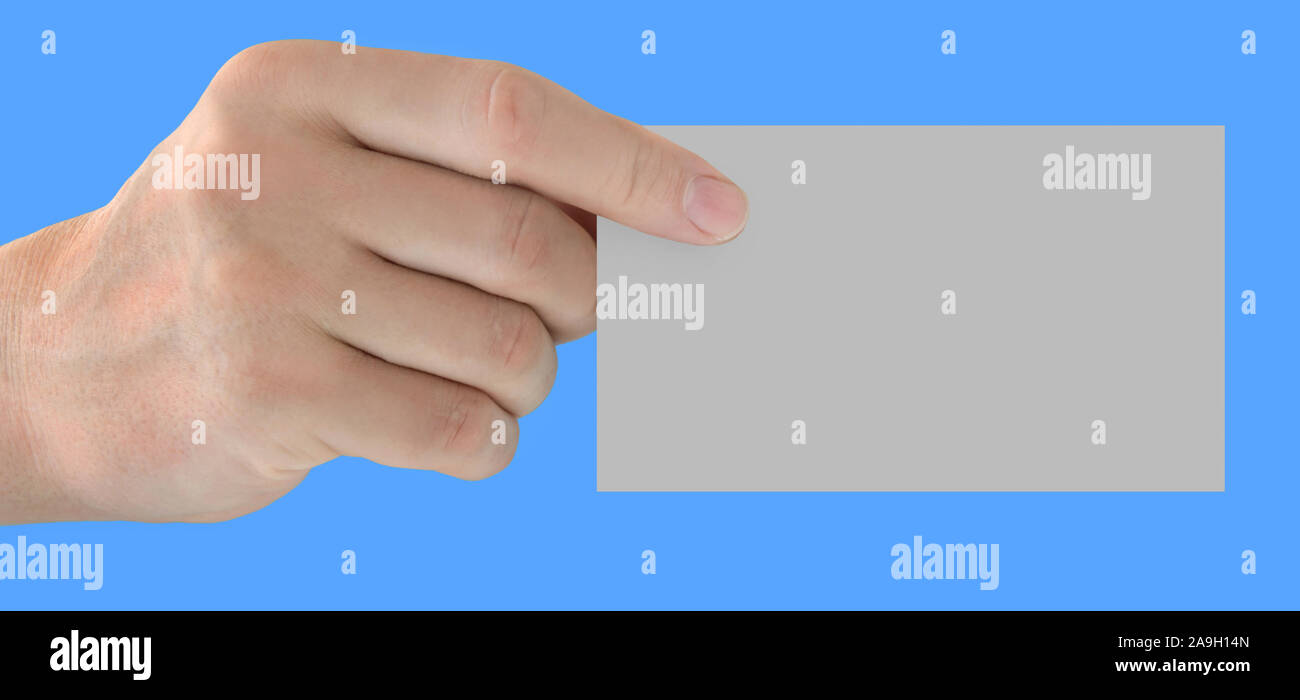 Male Hand and label against blue background Stock Photo - Alamy