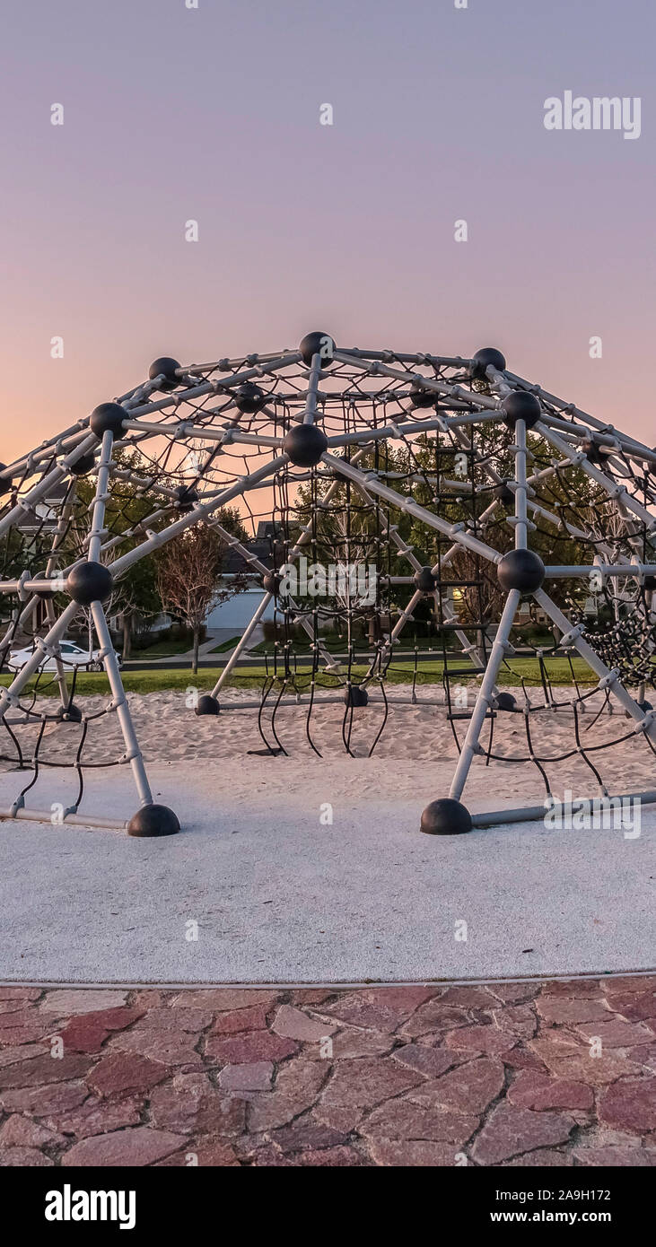 Vertical frame Metal climbing frame in a playground at sunset Stock ...