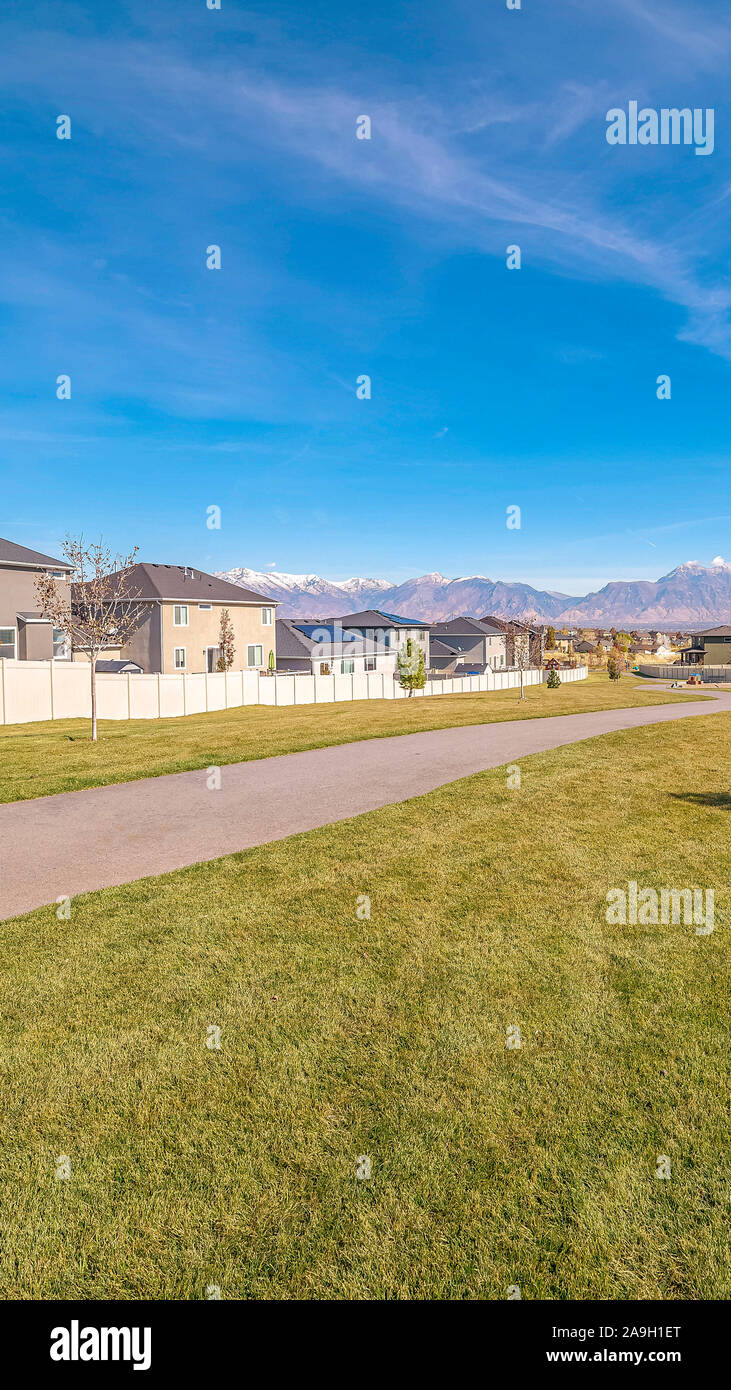 Vertical frame Paved walkway through a residential estate near sunset ...