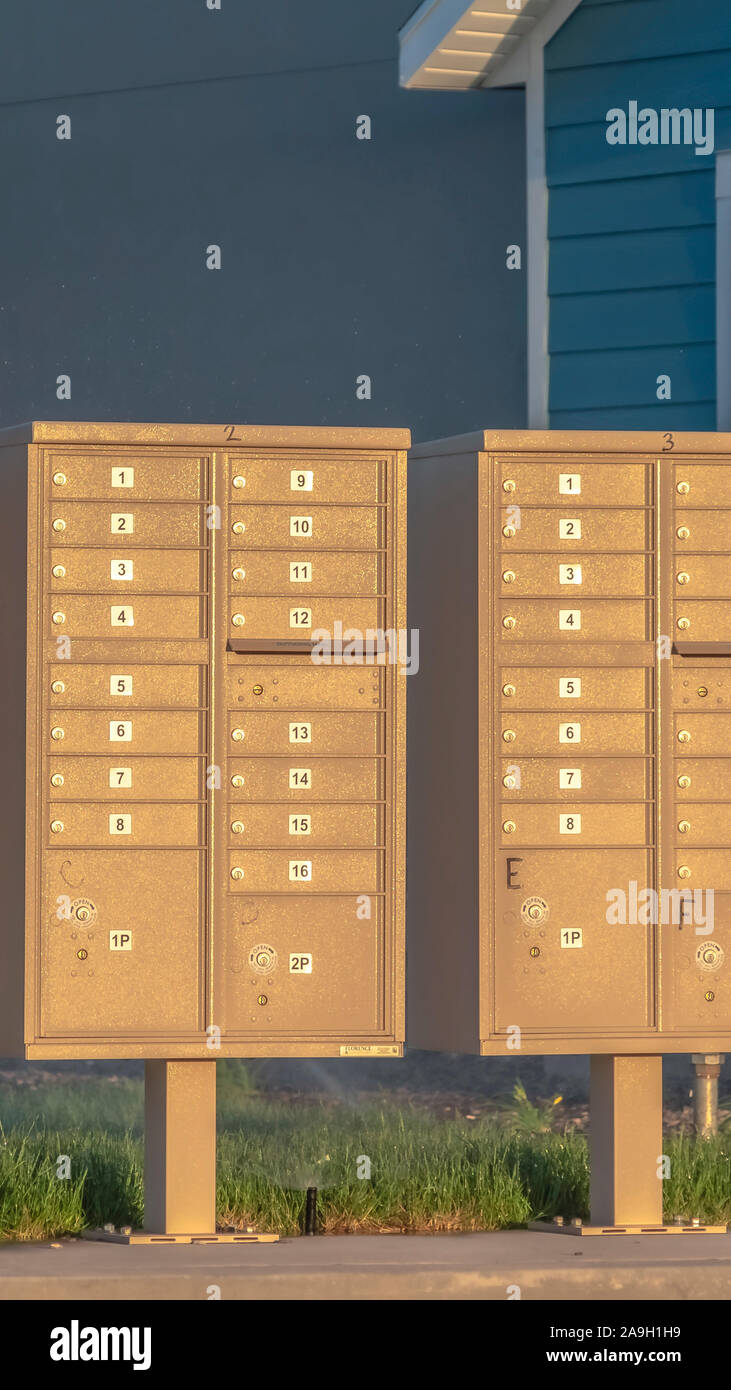 Vertical frame Row of mailboxes with numbers and compartments beside a ...