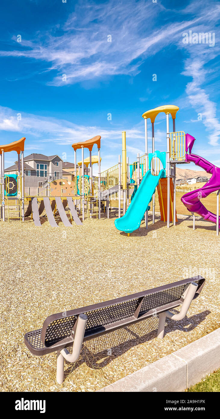 Vertical frame Small kids playground with colorful slides during day ...