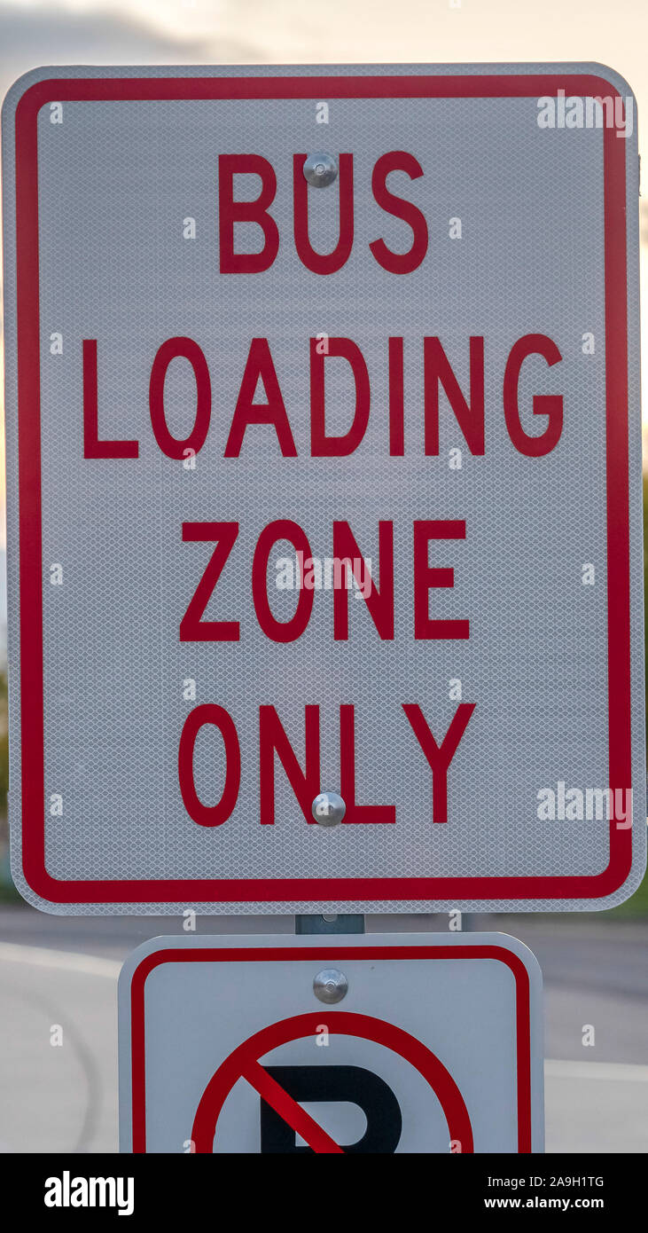 Vertical frame Traffic signs for a buss loading zone Stock Photo - Alamy