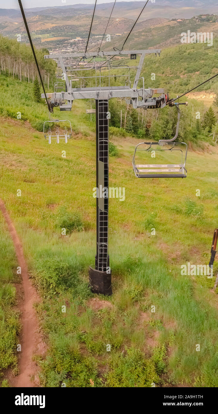 Vertical frame Sunny off season view in Park City ski resort with ...