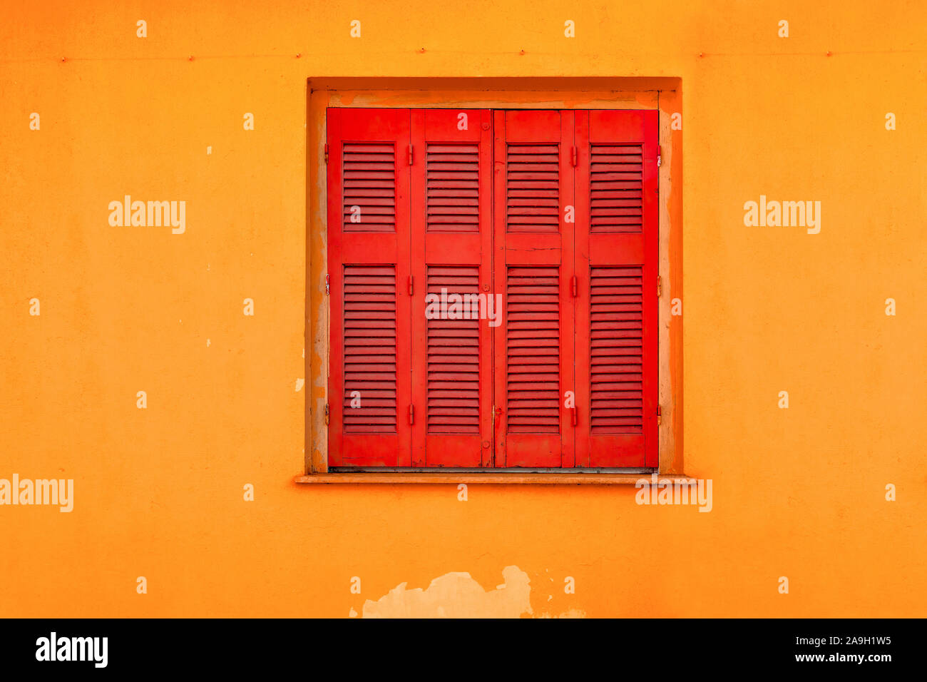 Red shutters with yellow wall. Exterior of red shutters and yellow wall ...
