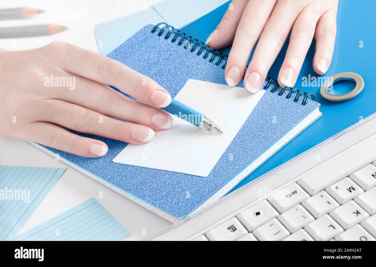 Notepad with female hand and ballpen Stock Photo - Alamy