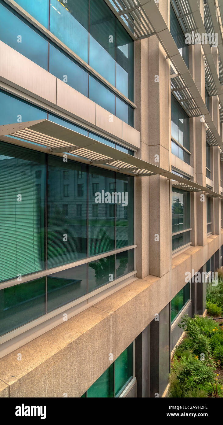 Vertical Office building exterior with close up on the glass windows ...