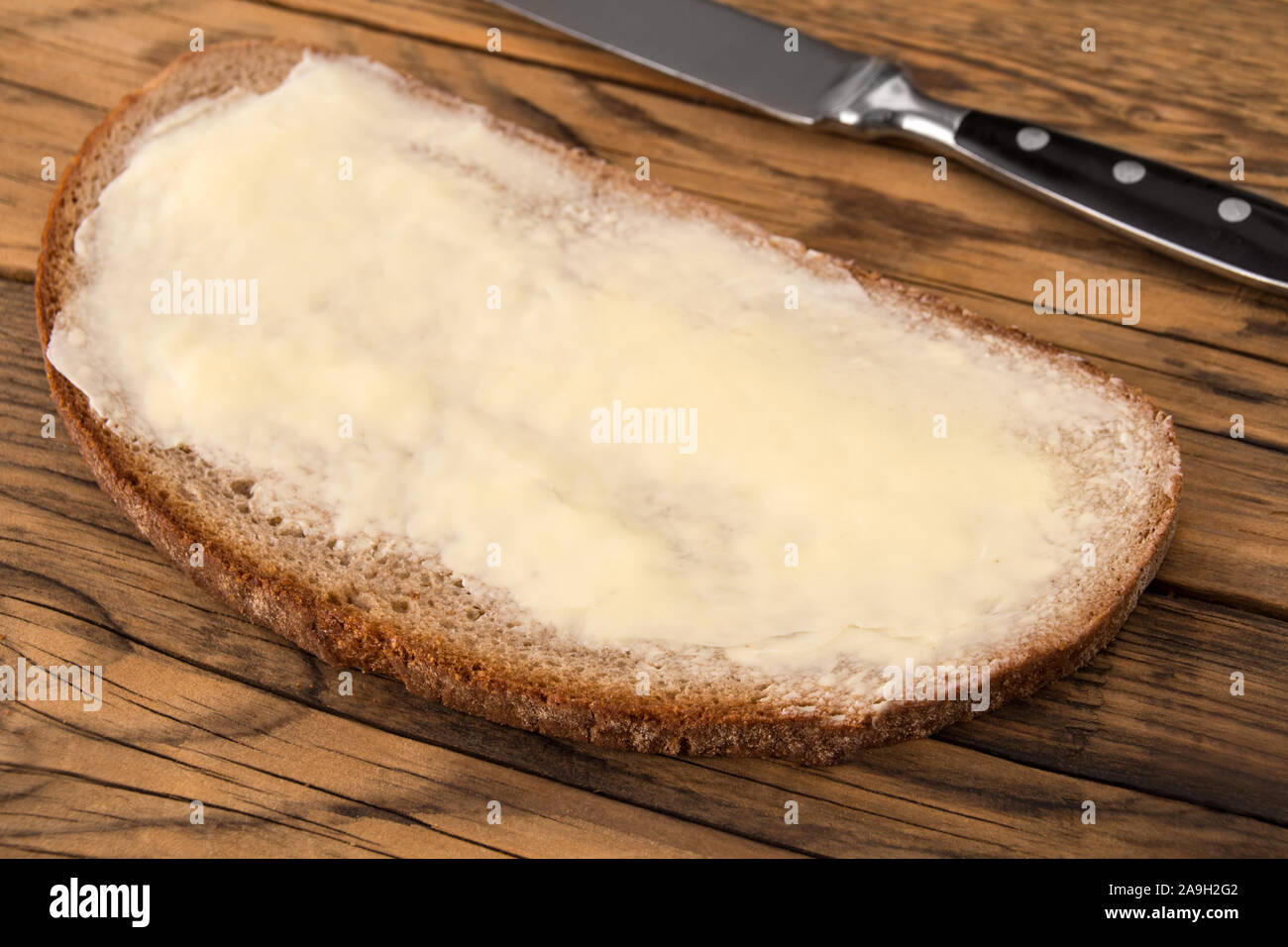 One slice of brown bread with butter Stock Photo - Alamy
