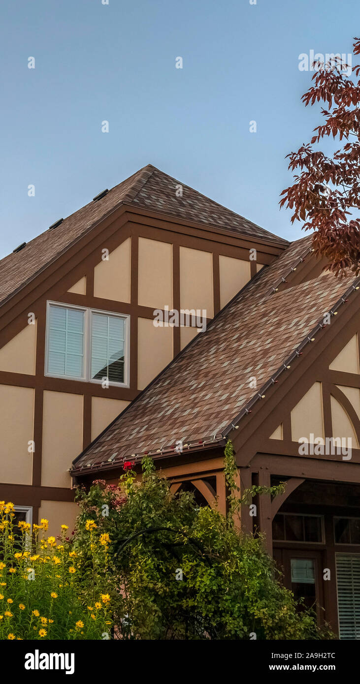 Vertical Unusual timber frame house with double apex roof Stock Photo ...