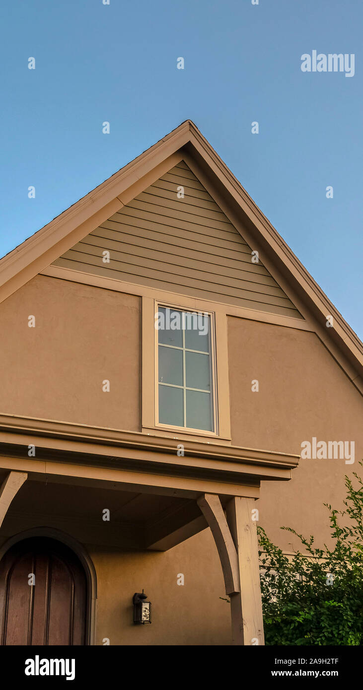 Vertical Top floor window in roof apex on a modern house Stock Photo ...