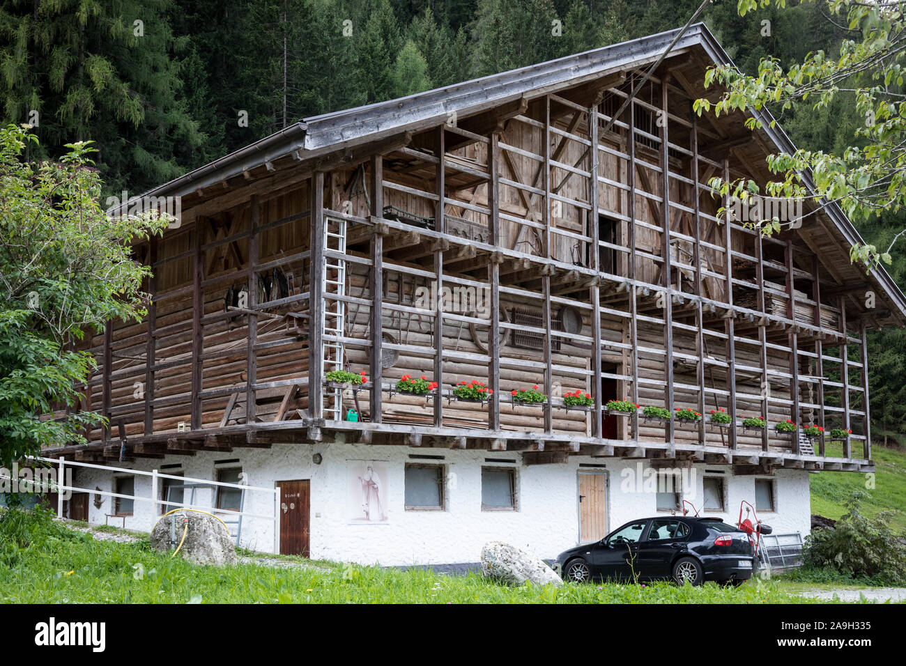 Very large wooden barn on the mountain side outside Ortisei Stock Photo ...